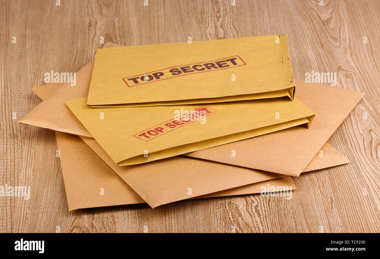 Envelopes with top secret stamp on wooden background Stock Photo - Alamy