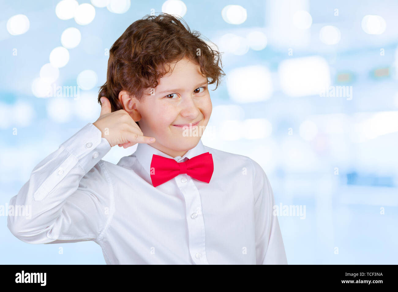 Boy making call me gesture sign with hand shaped like phone Stock Photo ...
