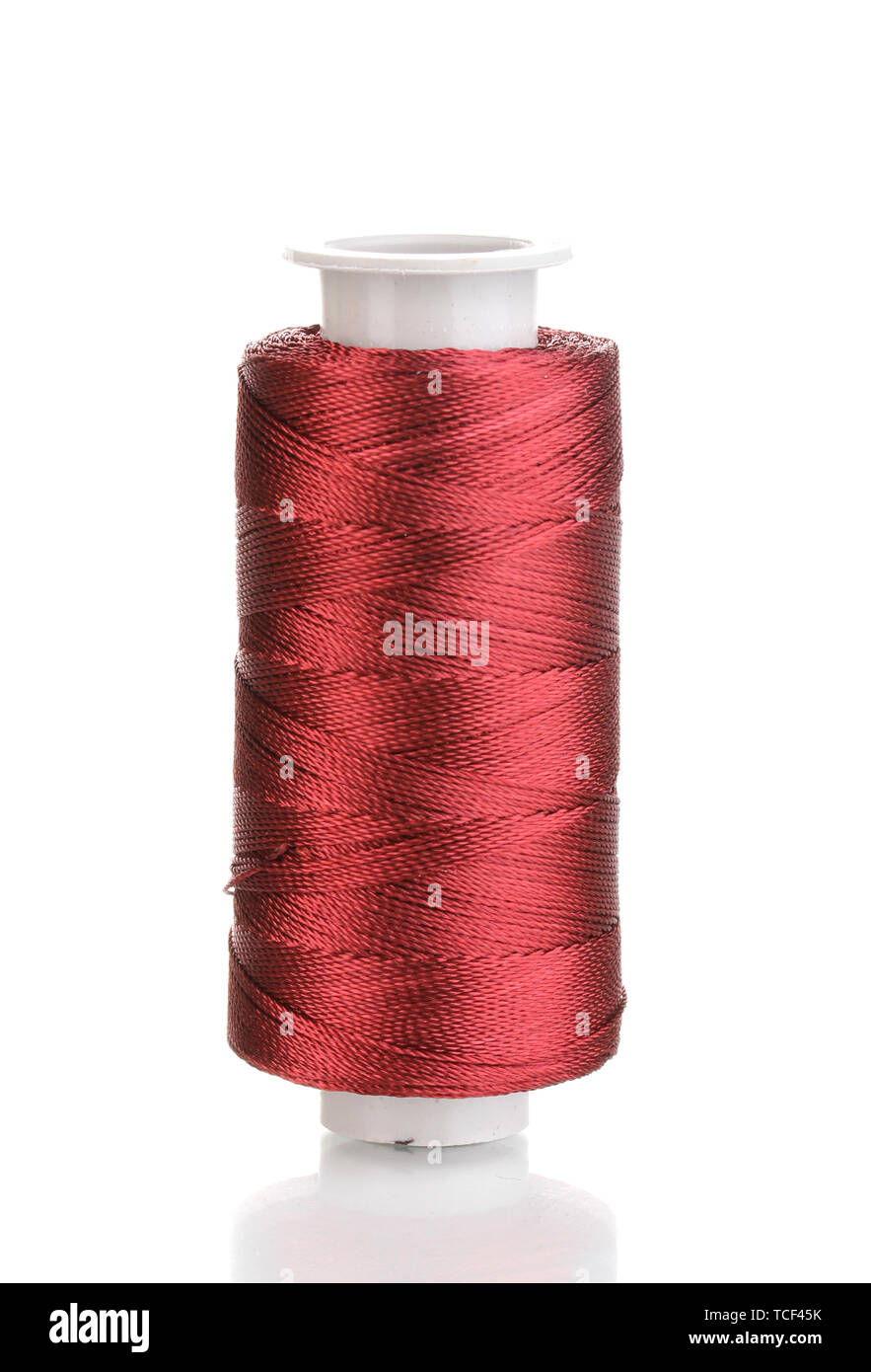 Brown bobbin thread isolated on white Stock Photo - Alamy