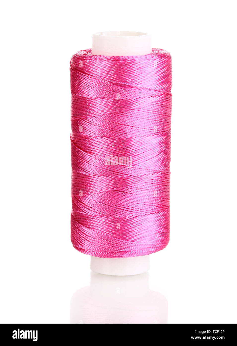 Pink bobbin thread isolated on white Stock Photo - Alamy