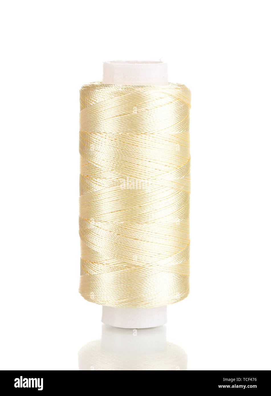 Gold bobbin thread isolated on white Stock Photo - Alamy