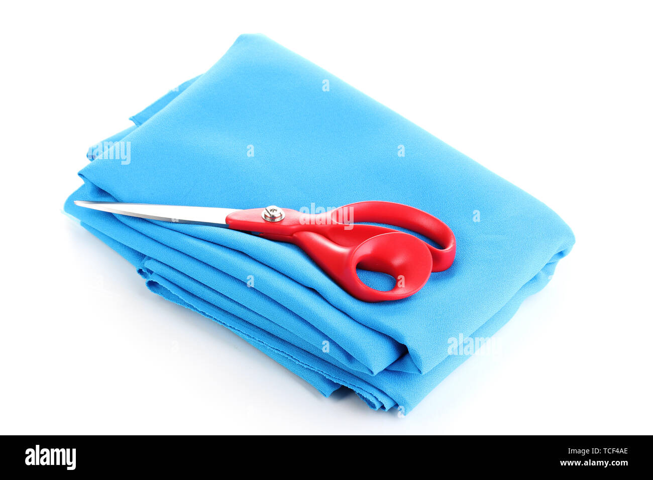 Scissors on fabric isolated on white Stock Photo - Alamy