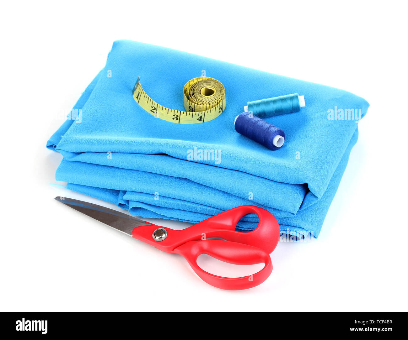 Scissors, bright thread, measuring tape and fabric isolated on white ...