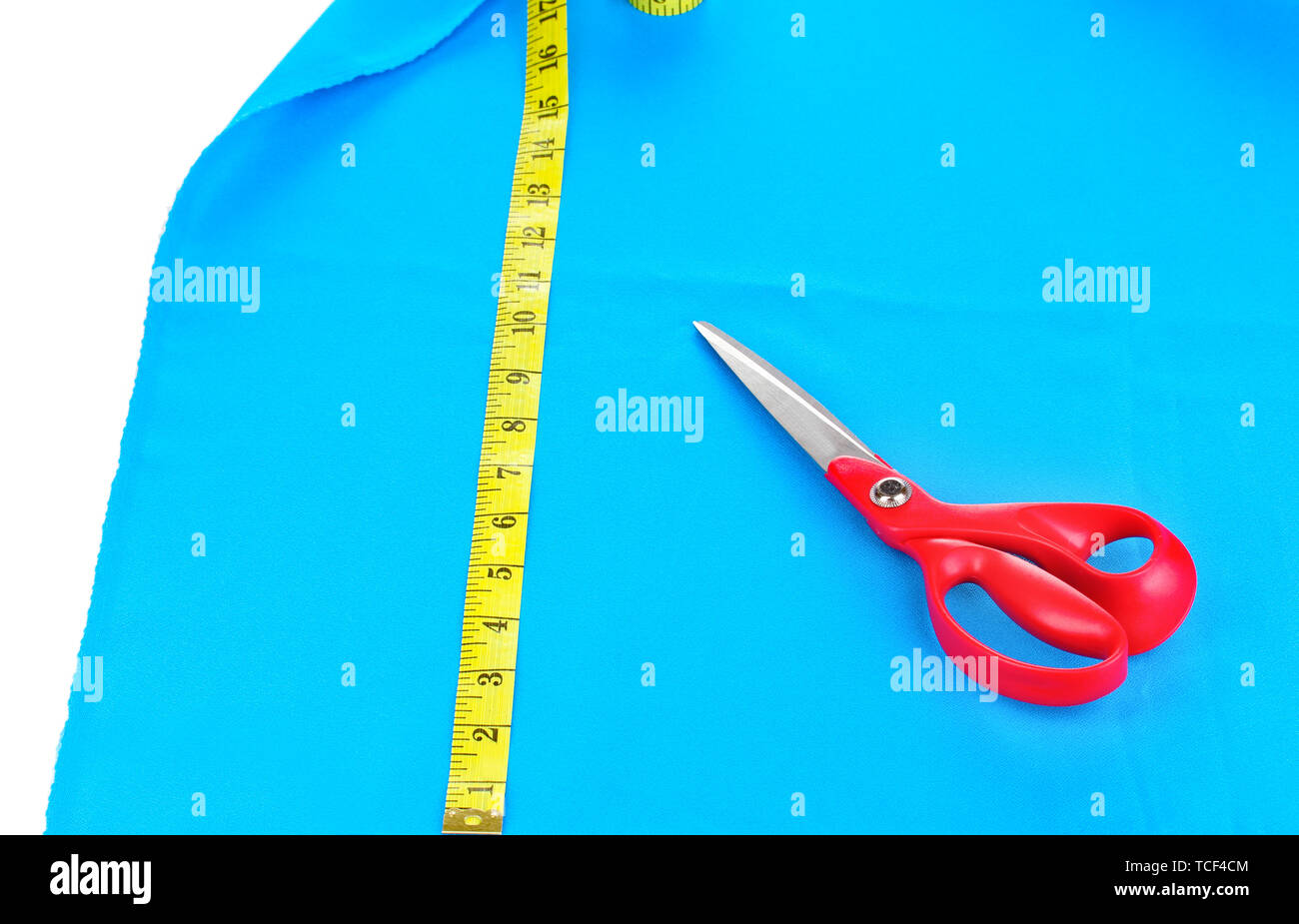 Scissors and measuring tape on fabric isolated on white Stock Photo - Alamy