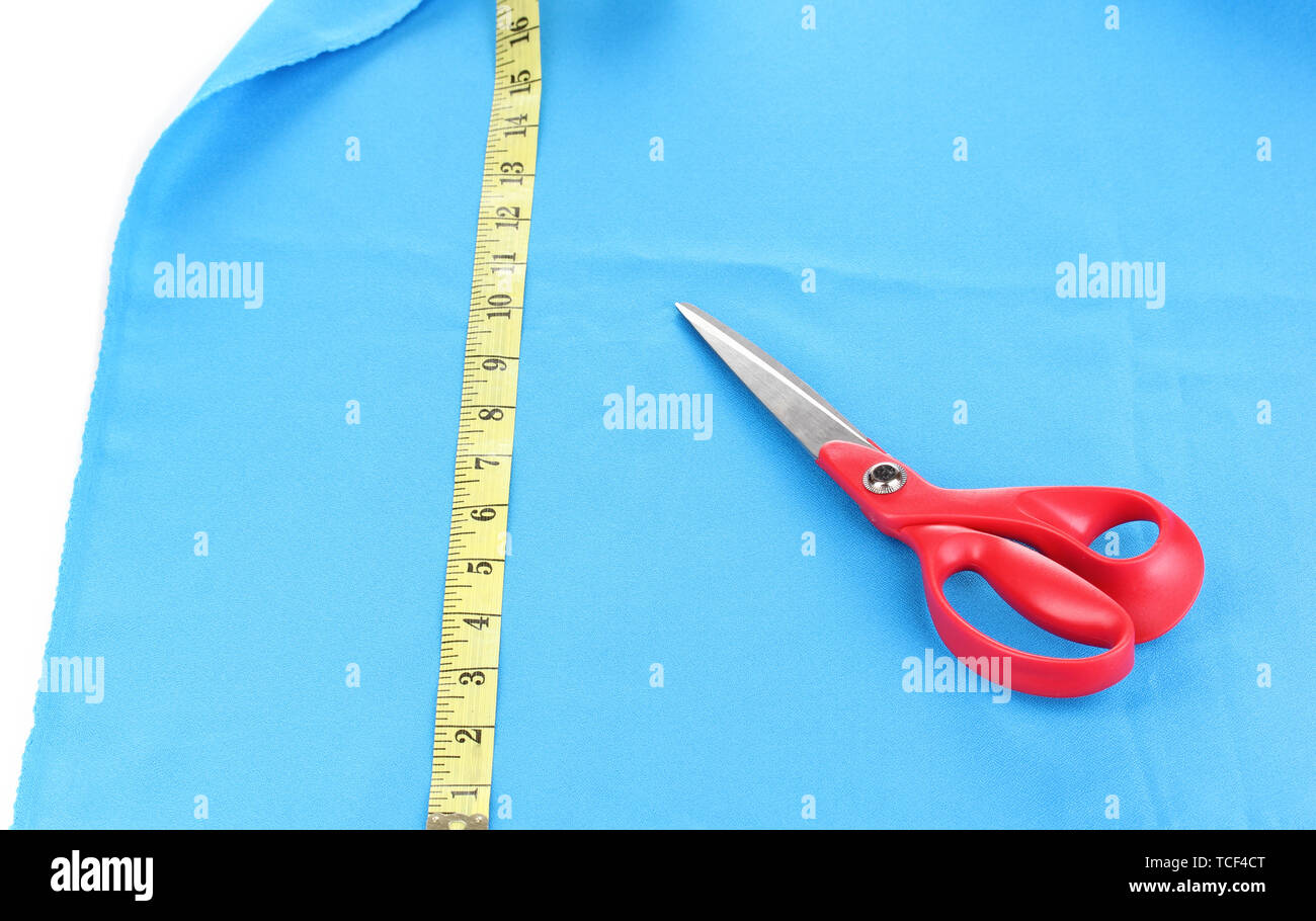 Scissors and measuring tape on fabric isolated on white Stock Photo - Alamy
