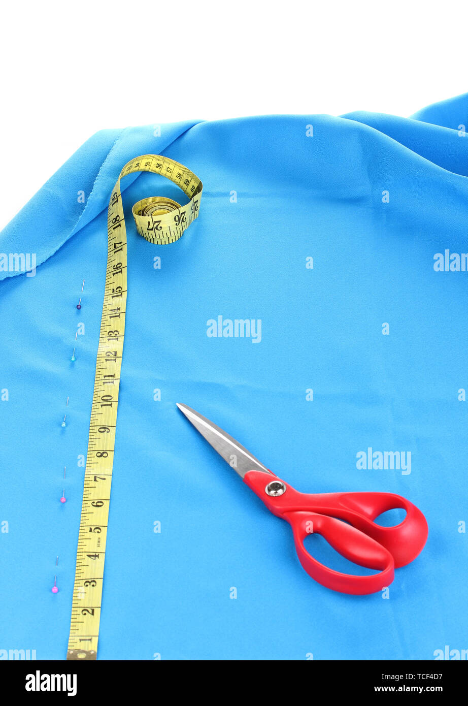 Scissors and measuring tape on fabric isolated on white Stock Photo - Alamy