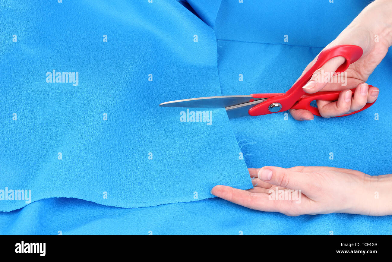 Woman cutting fabric Stock Photo - Alamy