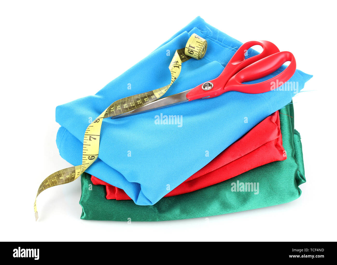 Scissors and measuring tape on fabric isolated on white Stock Photo - Alamy
