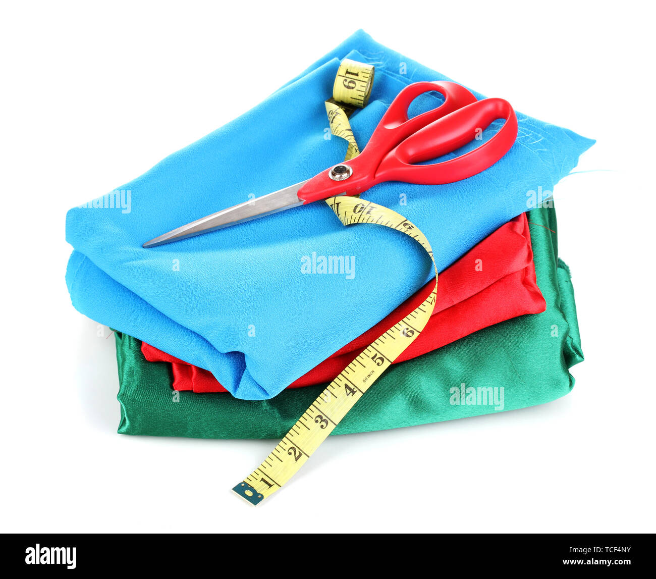 Scissors and measuring tape on fabric isolated on white Stock Photo - Alamy
