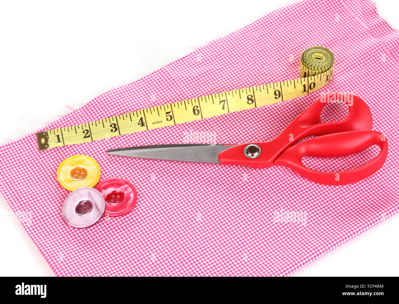 Scissors and measuring tape on fabric isolated on white Stock Photo - Alamy