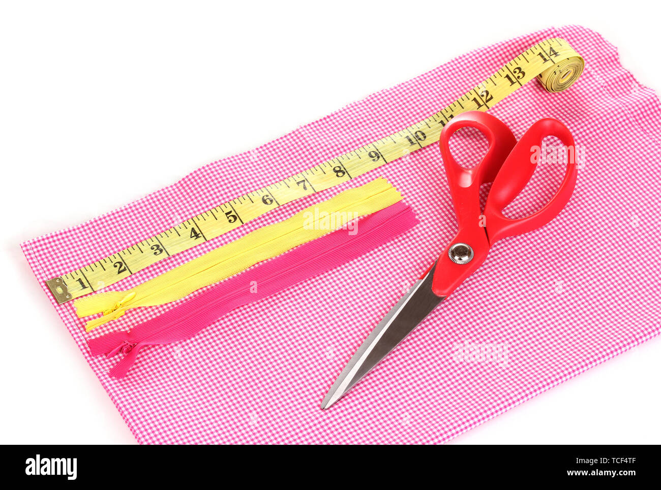 Scissors and measuring tape on fabric isolated on white Stock Photo - Alamy