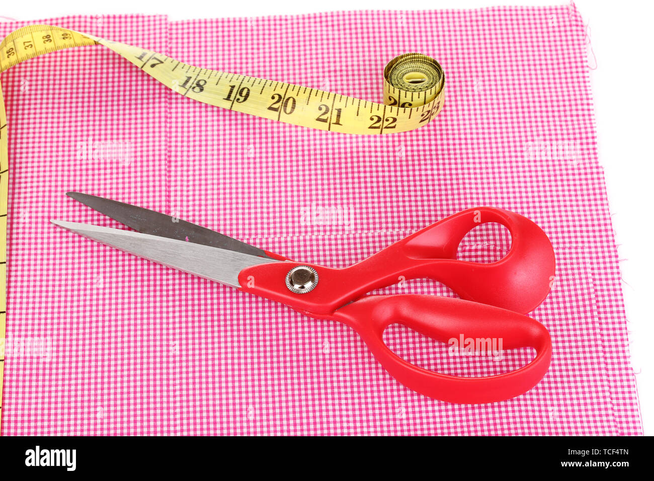 Scissors and measuring tape on fabric isolated on white Stock Photo - Alamy