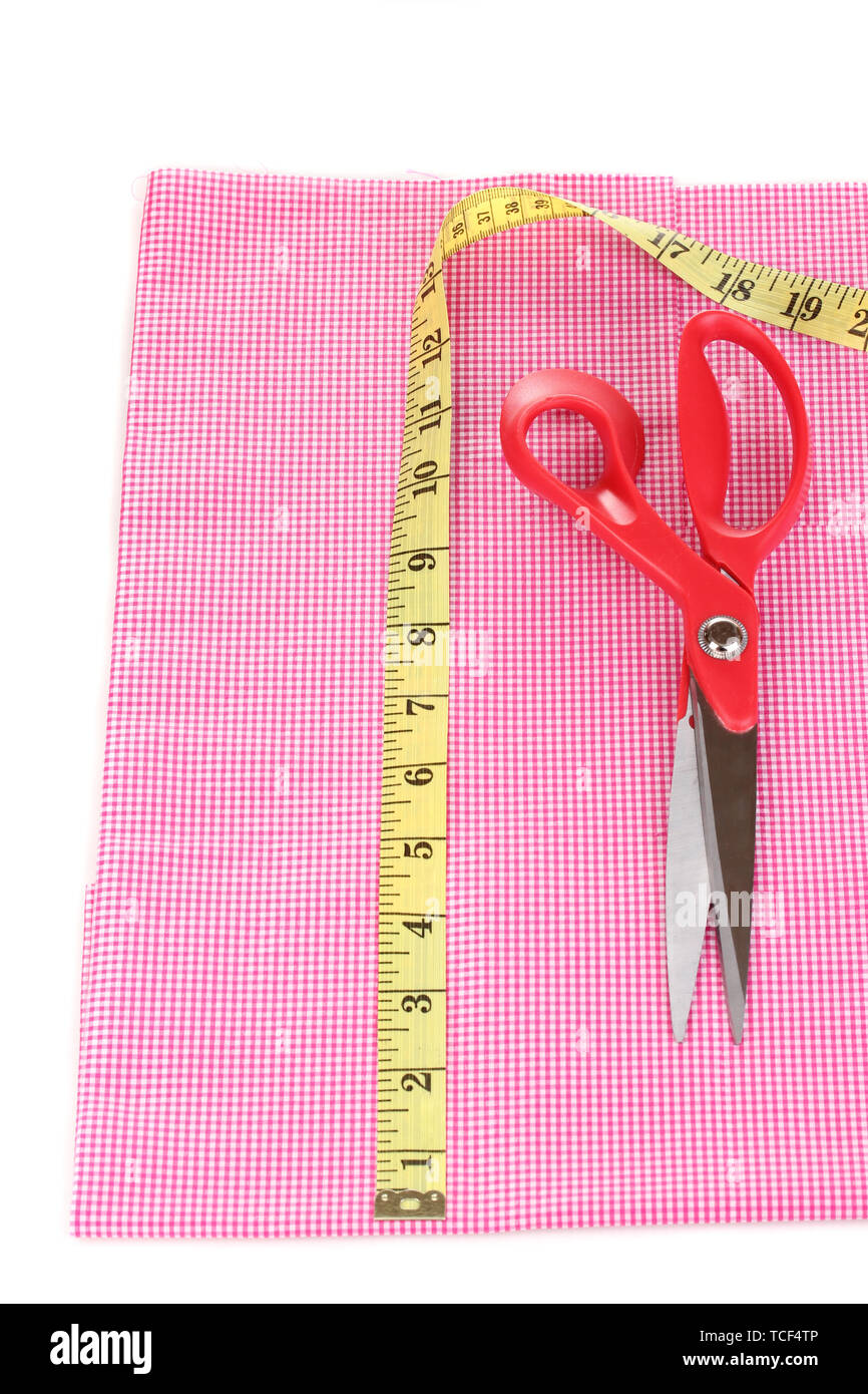 Scissors and measuring tape on fabric isolated on white Stock Photo - Alamy