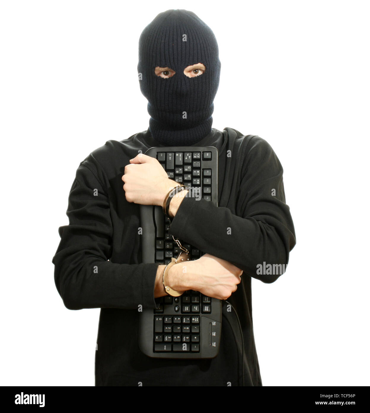 Hacker in black mask in handcuffs with keyboard isolated on white Stock ...