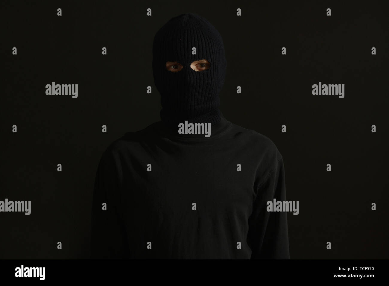 Bandit in black mask isolated on black Stock Photo - Alamy