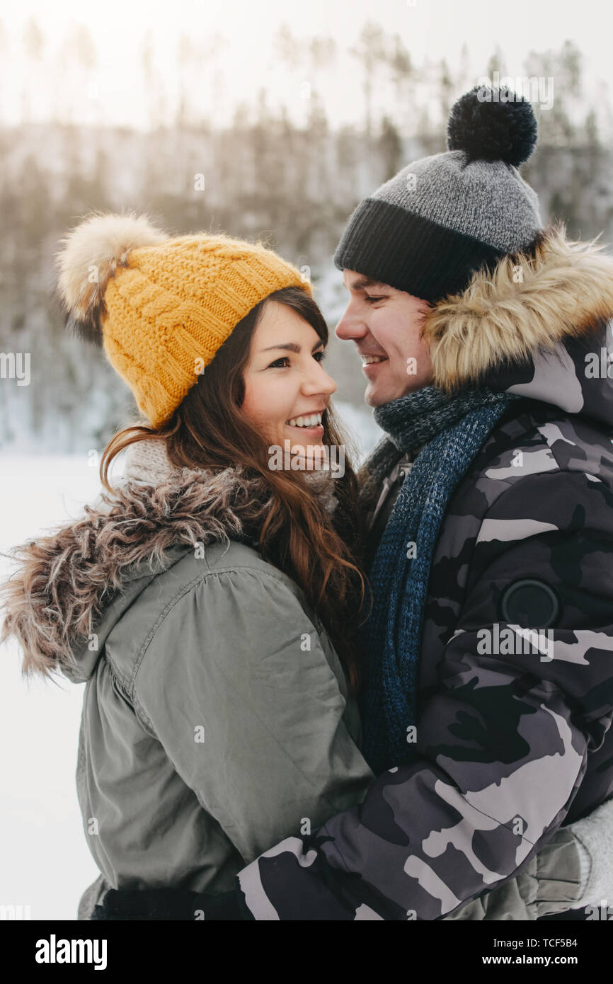 The happy couple in love at the forest nature park in cold season ...