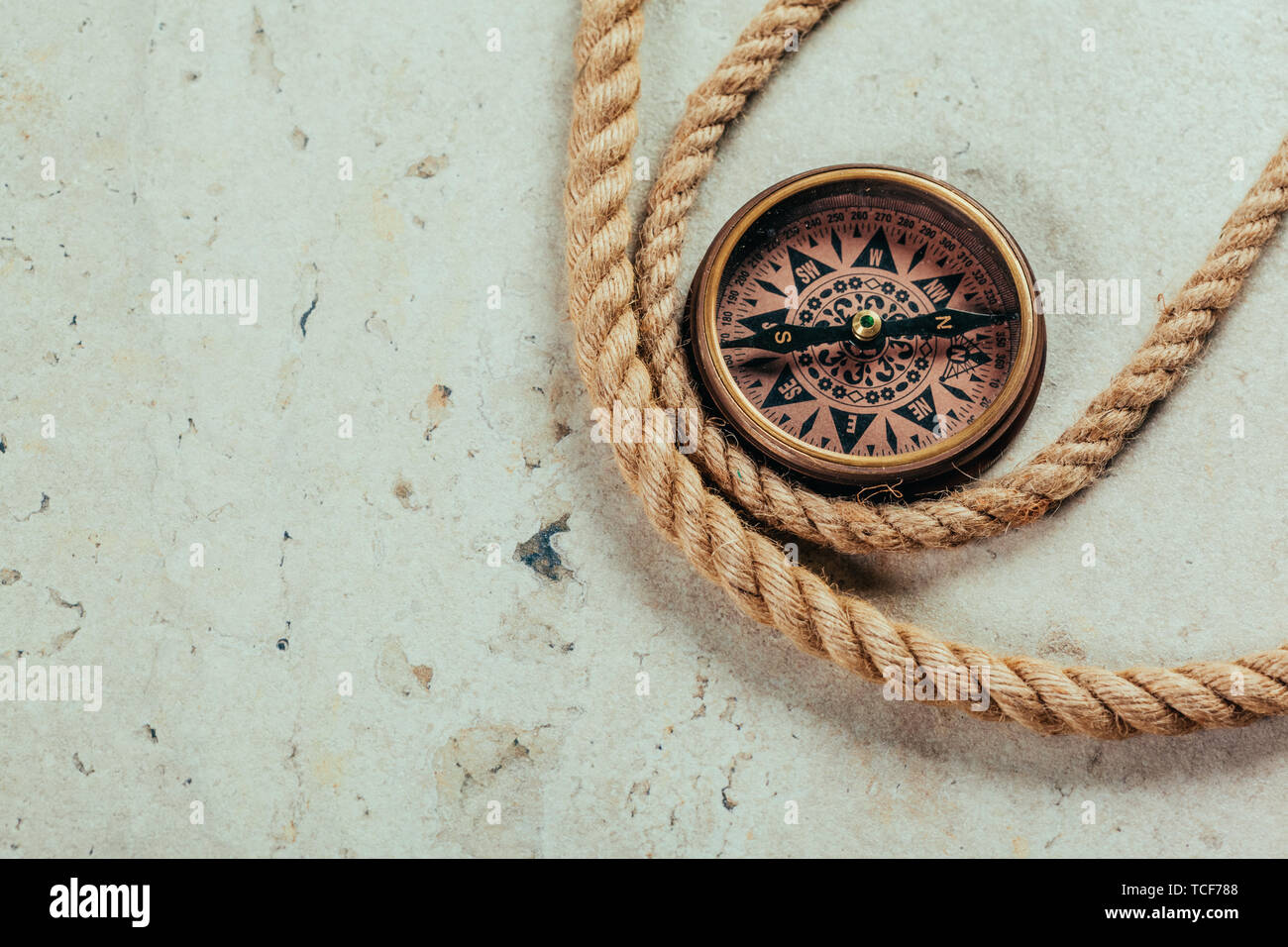 Compass on a gray gradient background Stock Photo - Alamy