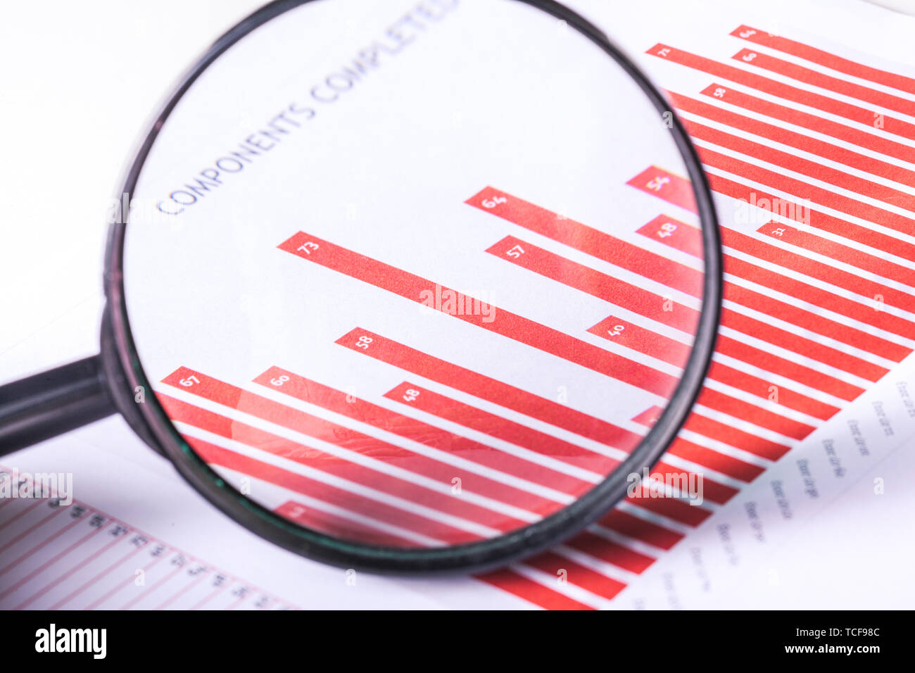 Magnifying glass and business growth graph Stock Photo - Alamy