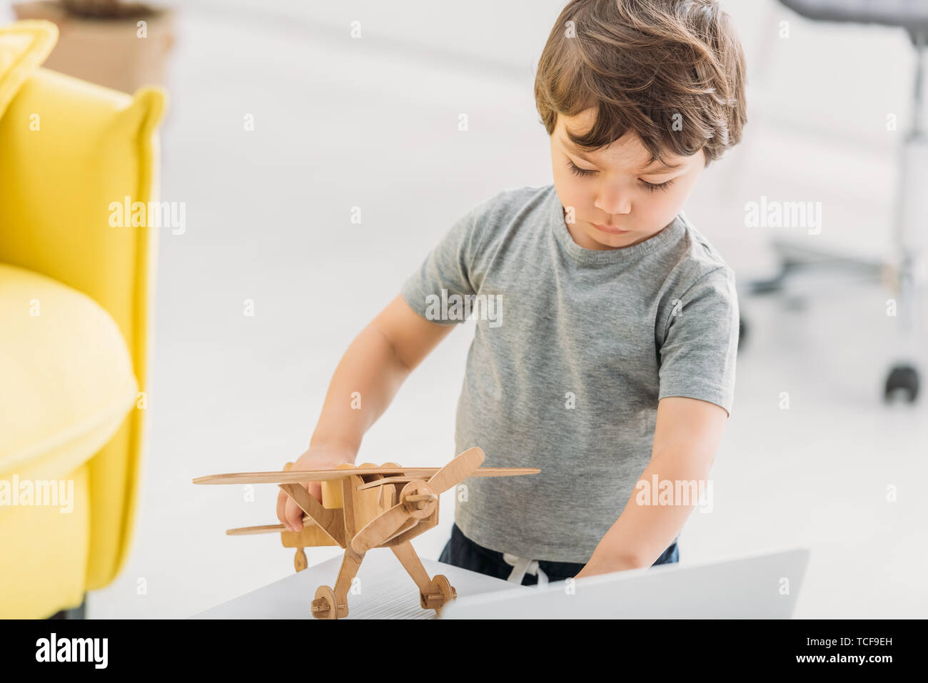 adorable boy playing with wooden plane model at home Stock Photo - Alamy