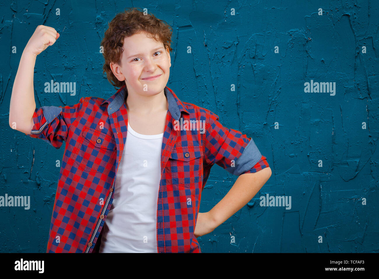 Close up portrait of strong smiling boy showing muscles Stock Photo - Alamy