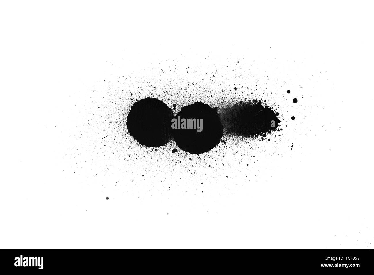 Black color spray paint on a white background paper Stock Photo - Alamy