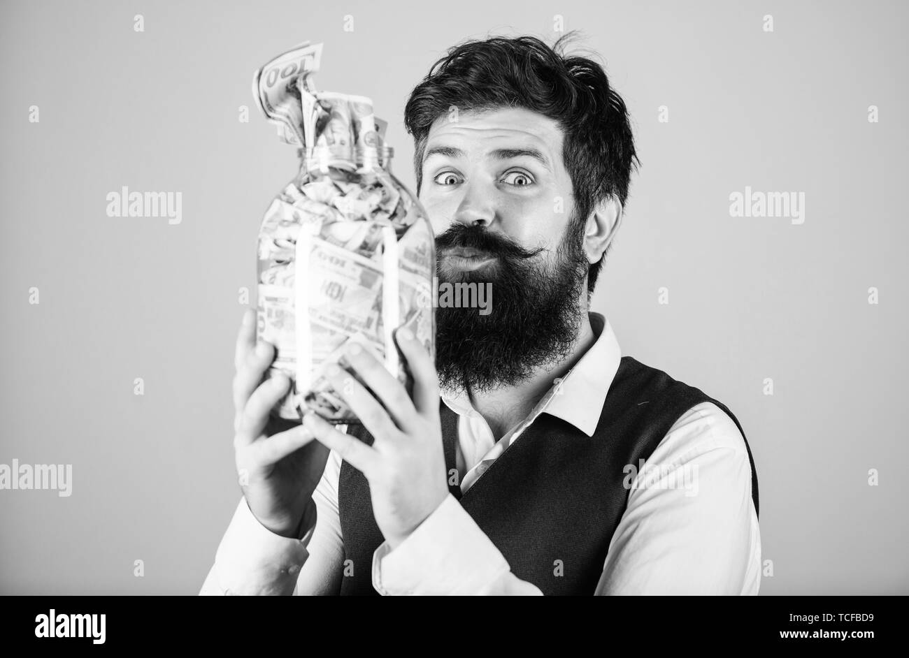 Man holding money jar Black and White Stock Photos & Images - Alamy