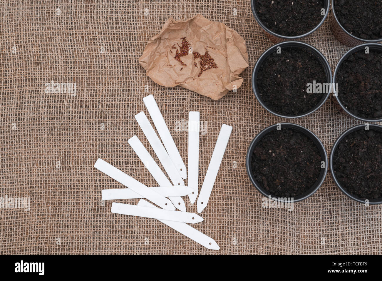 White tags and brown pots with soil on sackcloth background Stock Photo ...