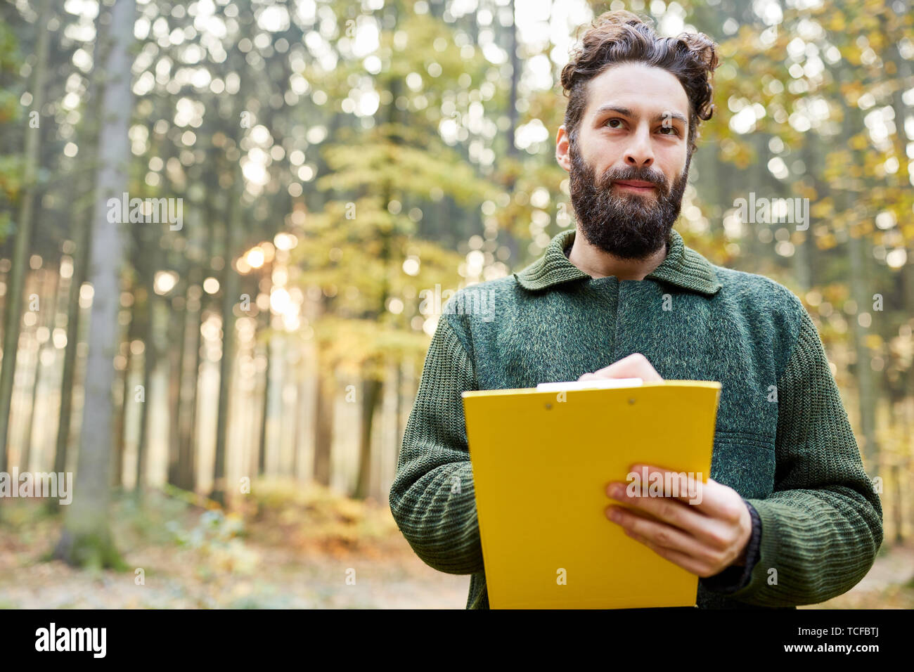 Forester with clipboard at forest monitoring controls the trees Stock ...
