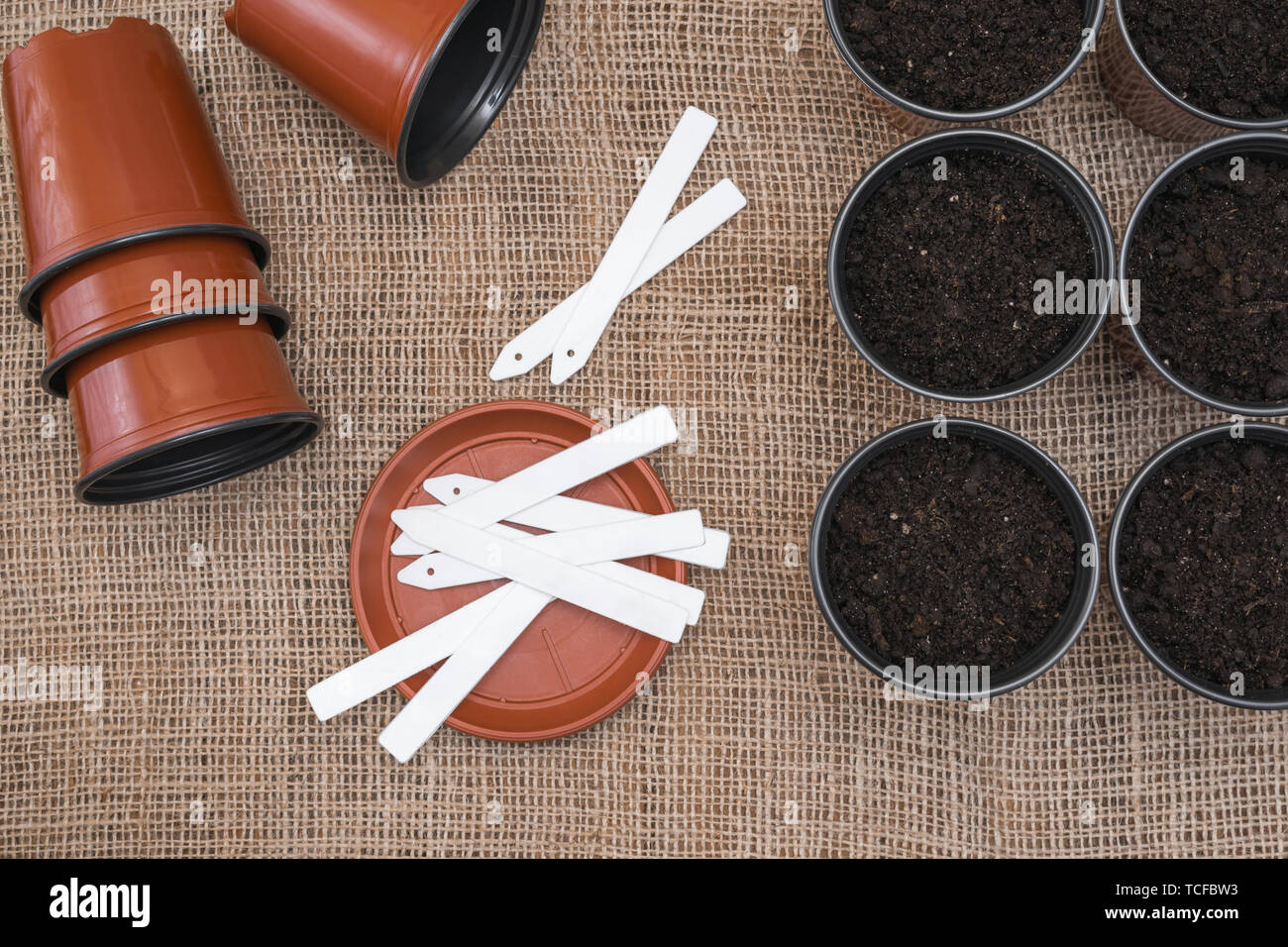 White tags and brown pots with soil on sackcloth background Stock Photo ...