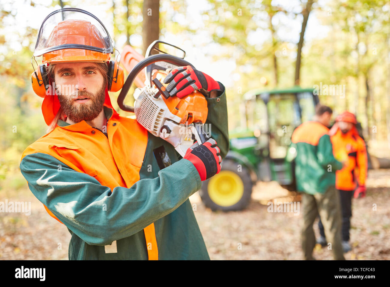 Forest worker or forest farmer as a woodcutter with chainsaw and in ...