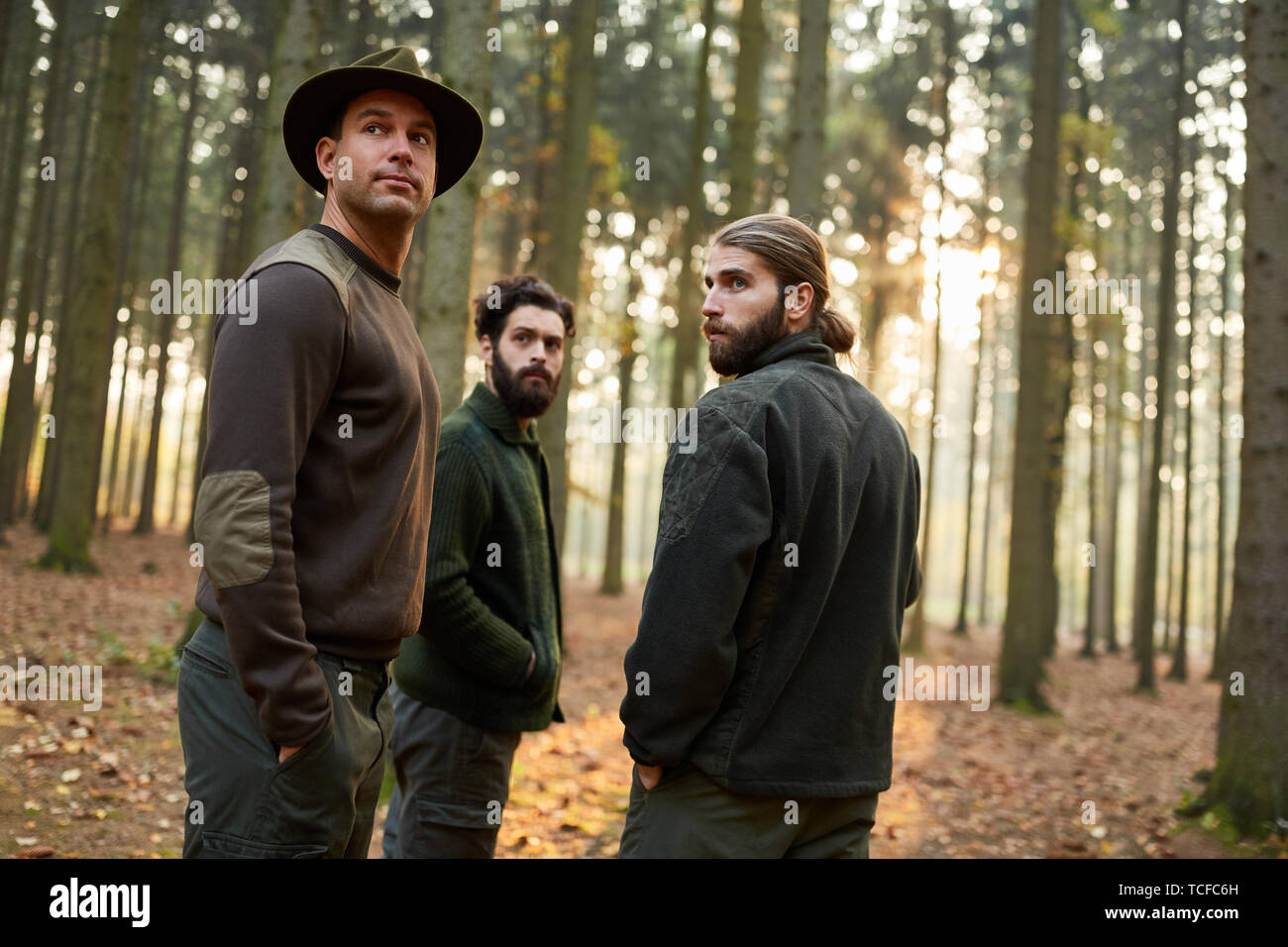 Group of foresters or foresters in the woods in autumn on a patrol ...