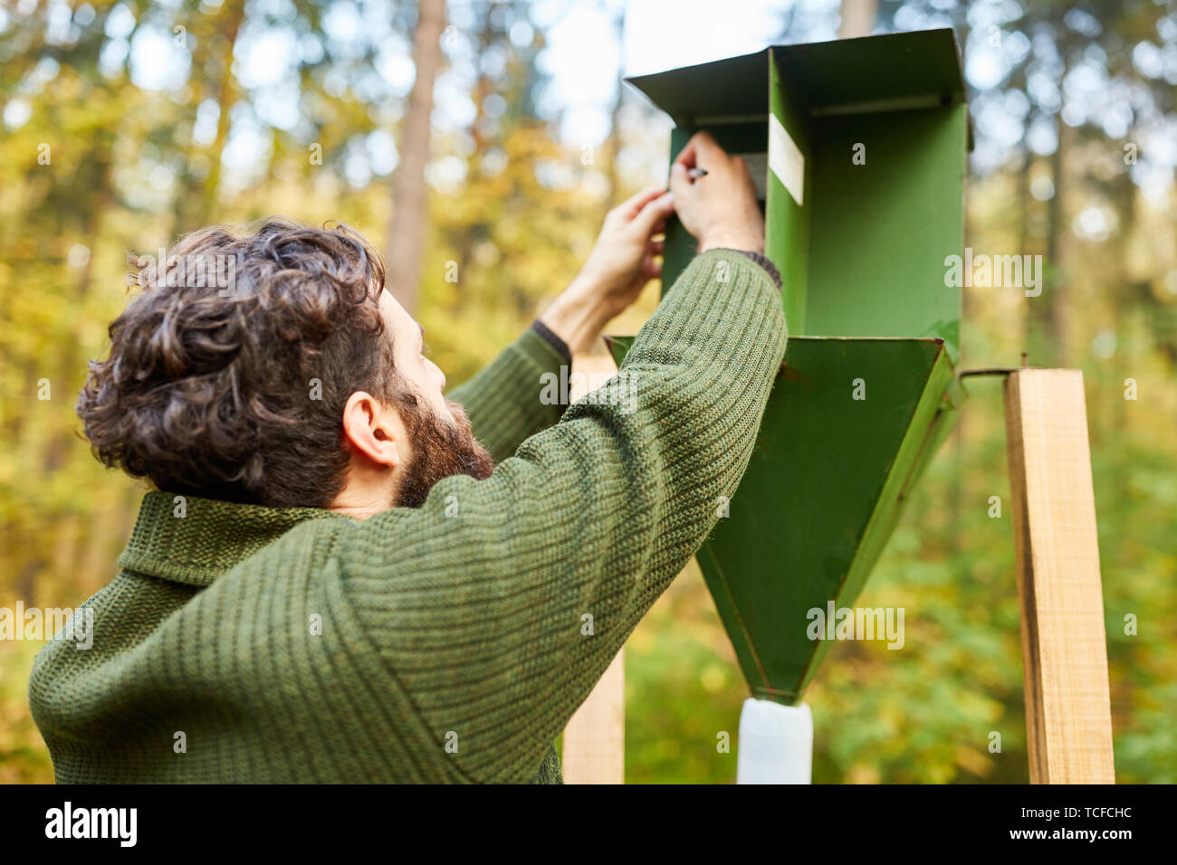 Forester on a bark beetle trap notes result of pest control Stock Photo ...
