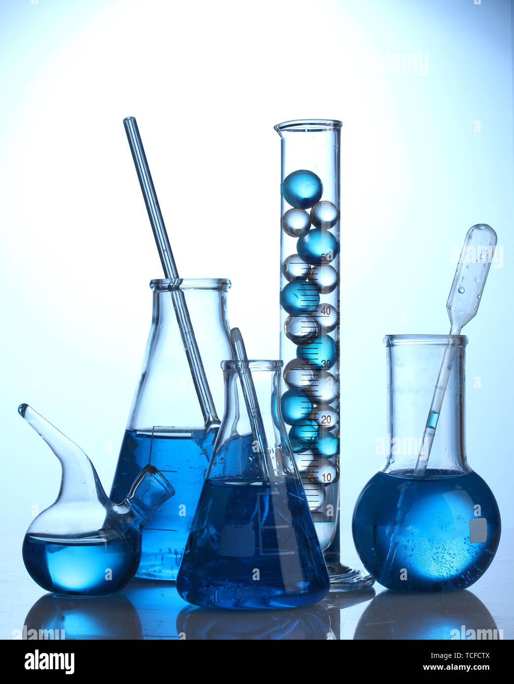 Test-tubes with blue liquid on blue background Stock Photo - Alamy