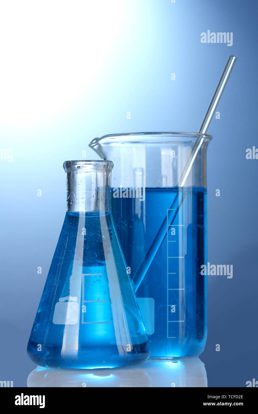 Test-tubes with blue liquid on blue background Stock Photo - Alamy