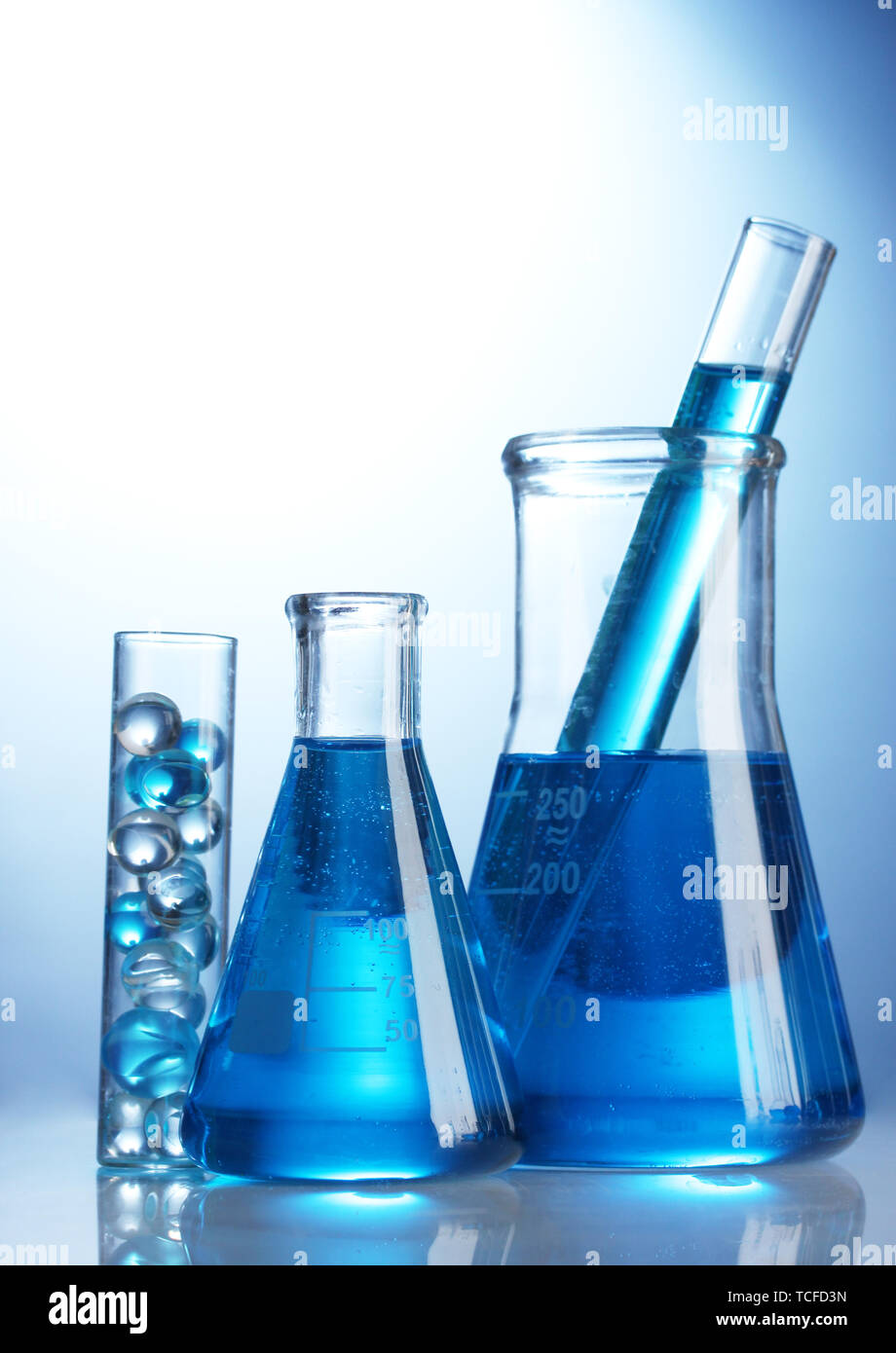 Test-tubes with blue liquid on blue background Stock Photo - Alamy