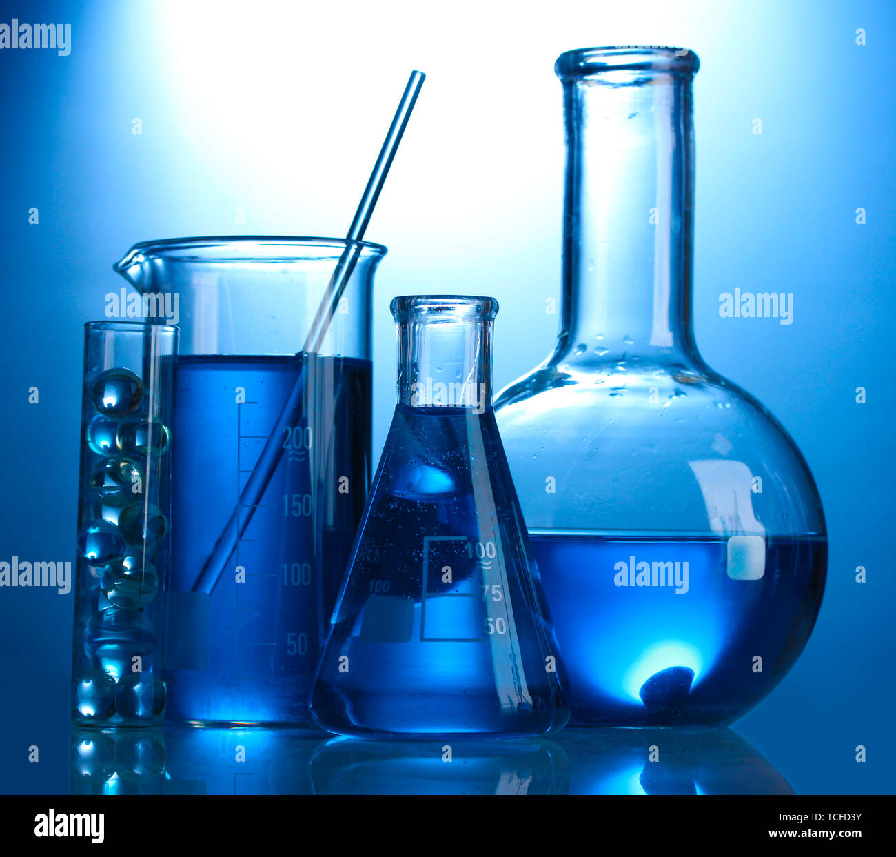 Test-tubes with blue liquid on blue background Stock Photo - Alamy