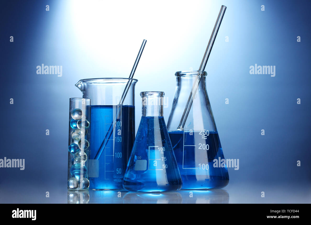 Test-tubes with blue liquid on blue background Stock Photo - Alamy
