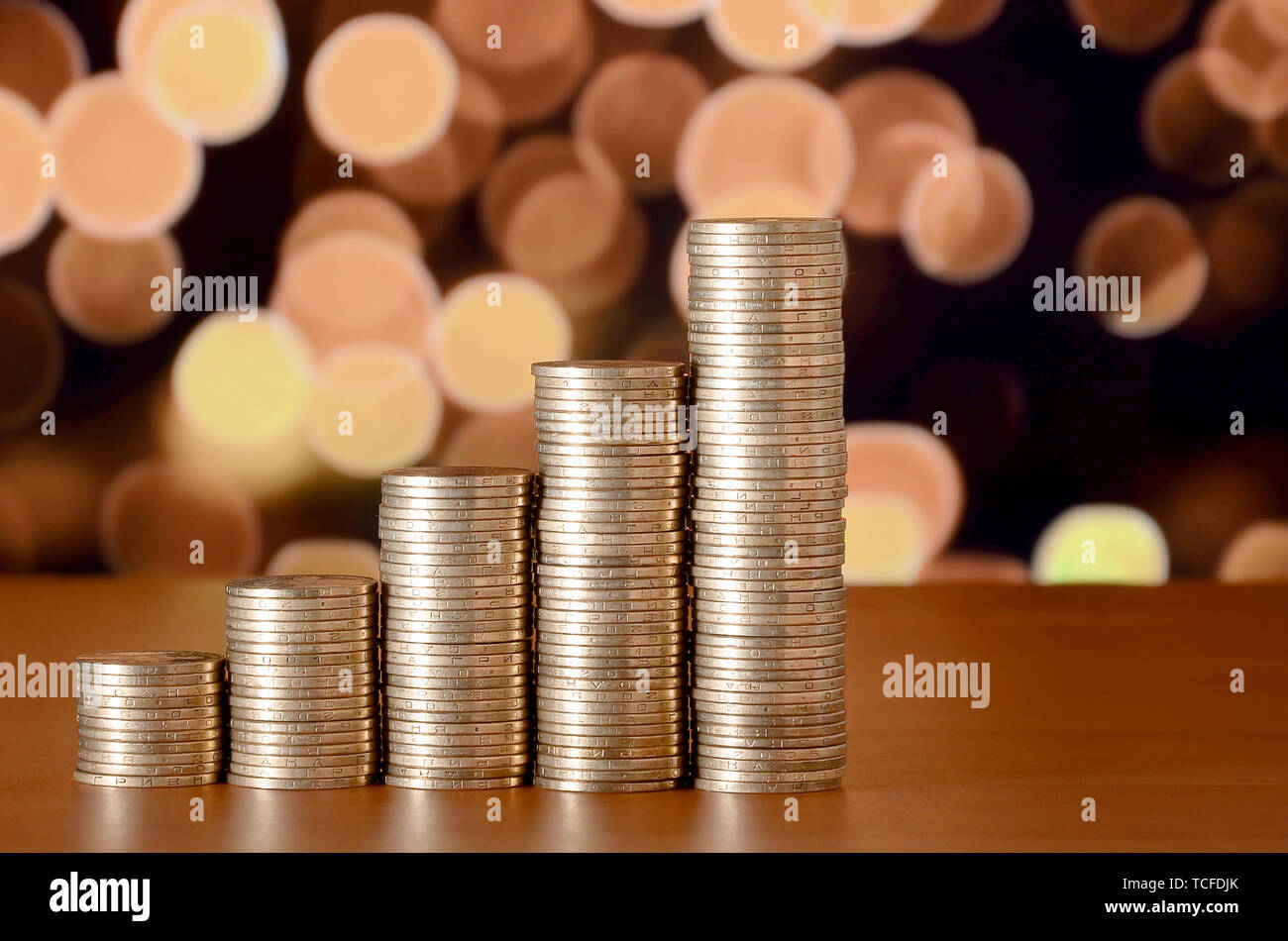 Golden coin stacks arranged as a graph. Increasing columns of coins ...