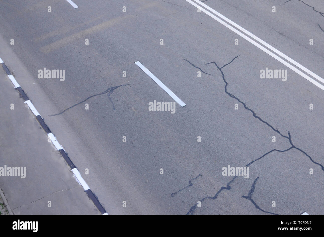 Damaged bad asphalt road with potholes. Patch repair of asphalt. Bad ...