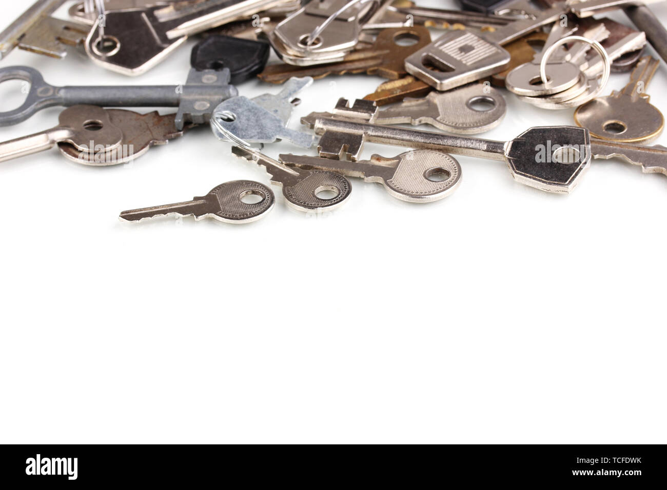 Lot of metal keys isolated on white Stock Photo - Alamy
