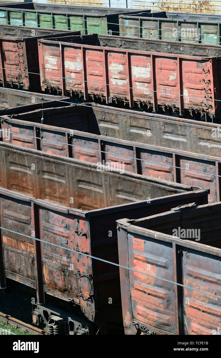 Old empty rusty train cars on rails in summer day. Dirty wagons in ...