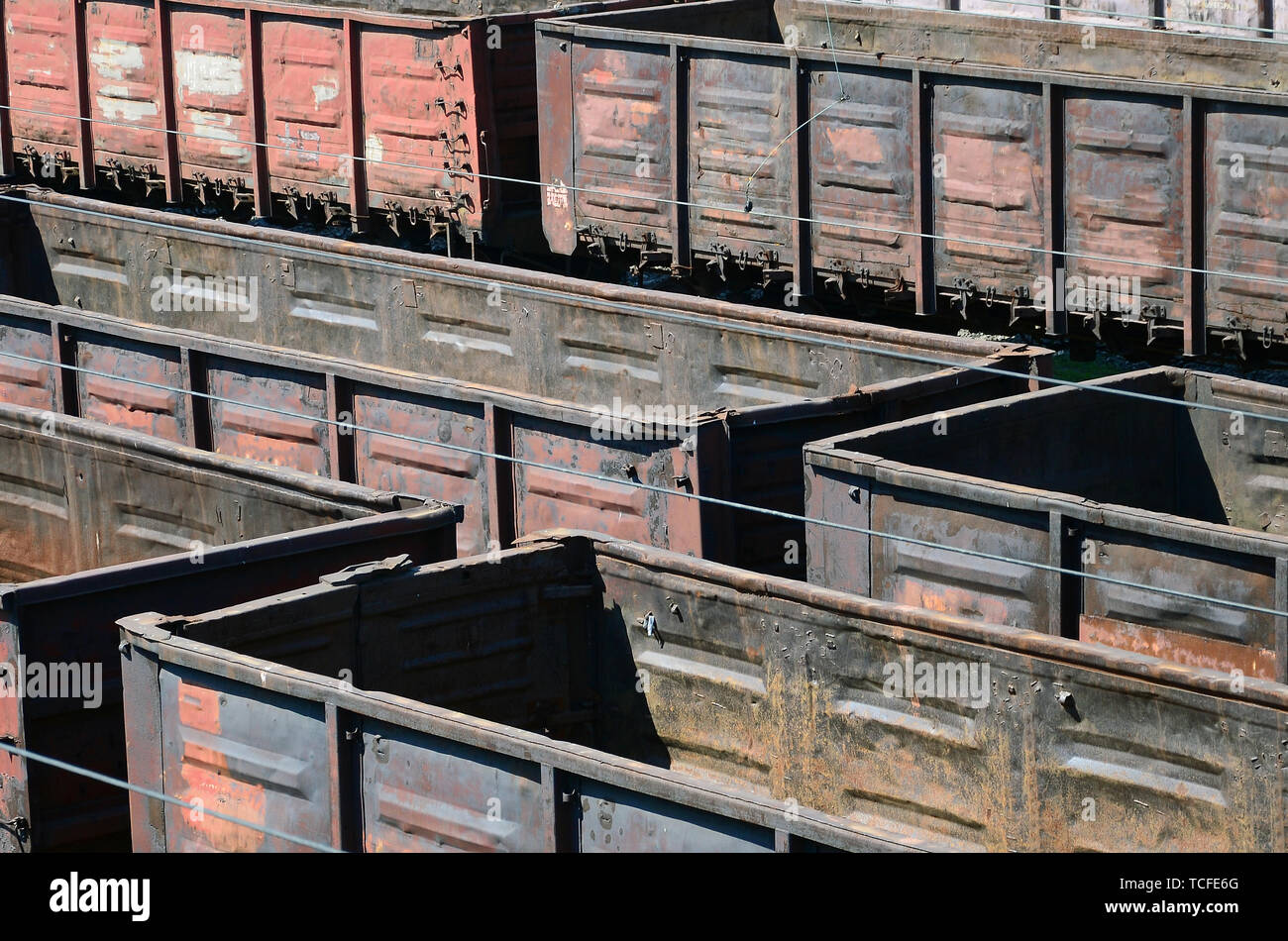 Old empty rusty train cars on rails in summer day. Dirty wagons in ...