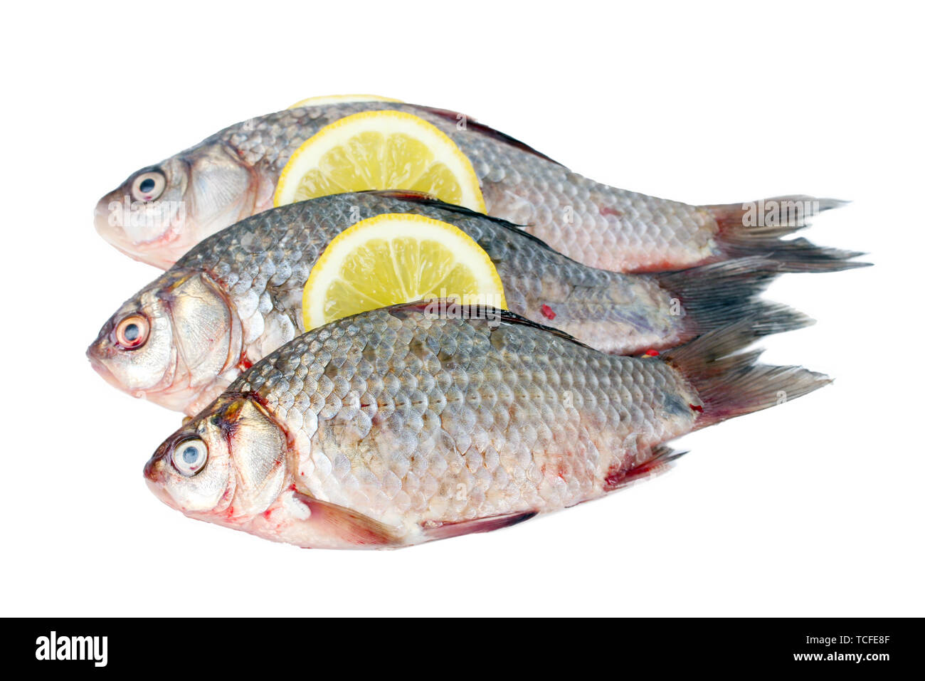 Fresh fishes with lemon isolated on white Stock Photo - Alamy
