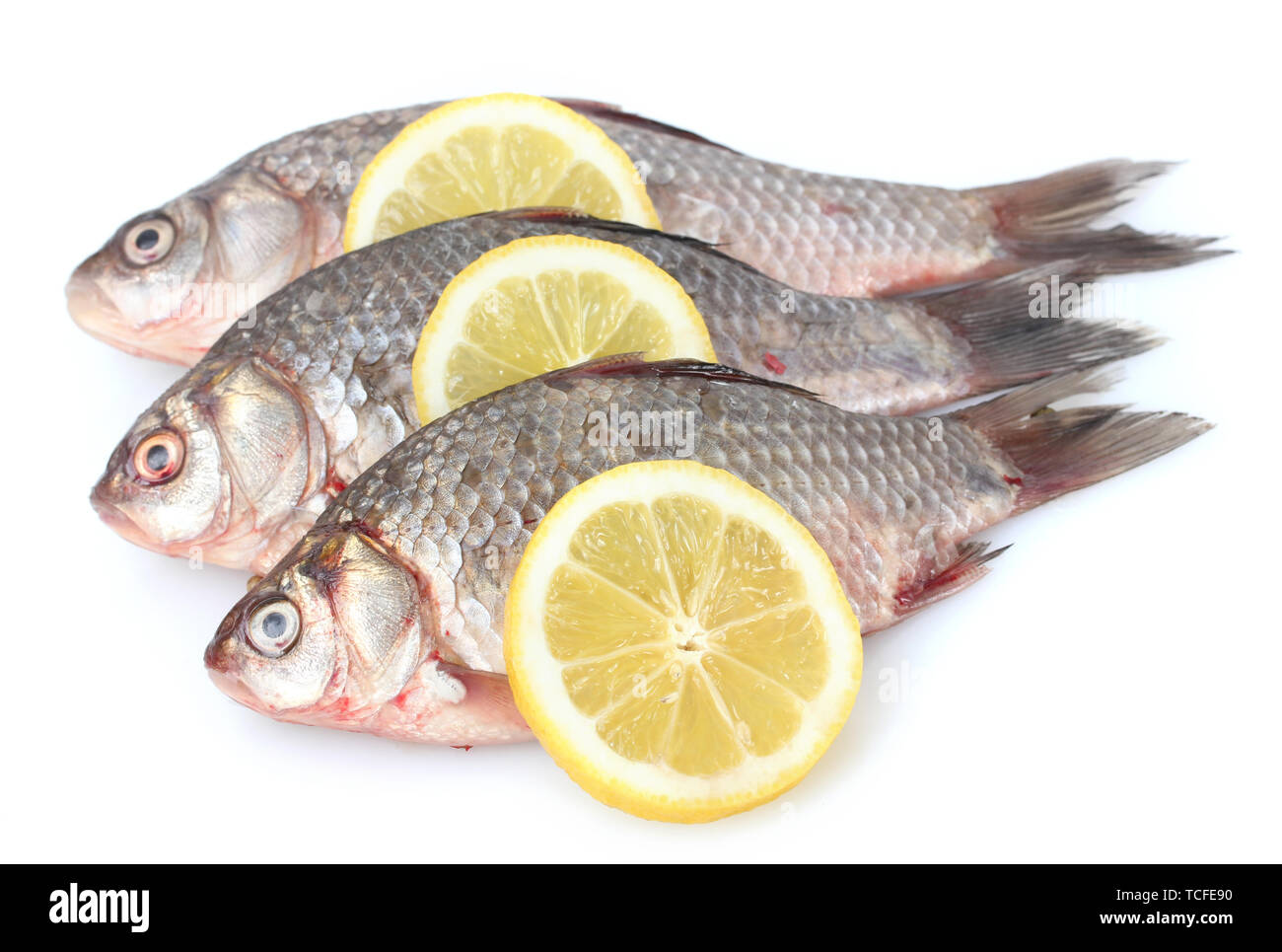 Fresh fishes with lemon isolated on white Stock Photo - Alamy