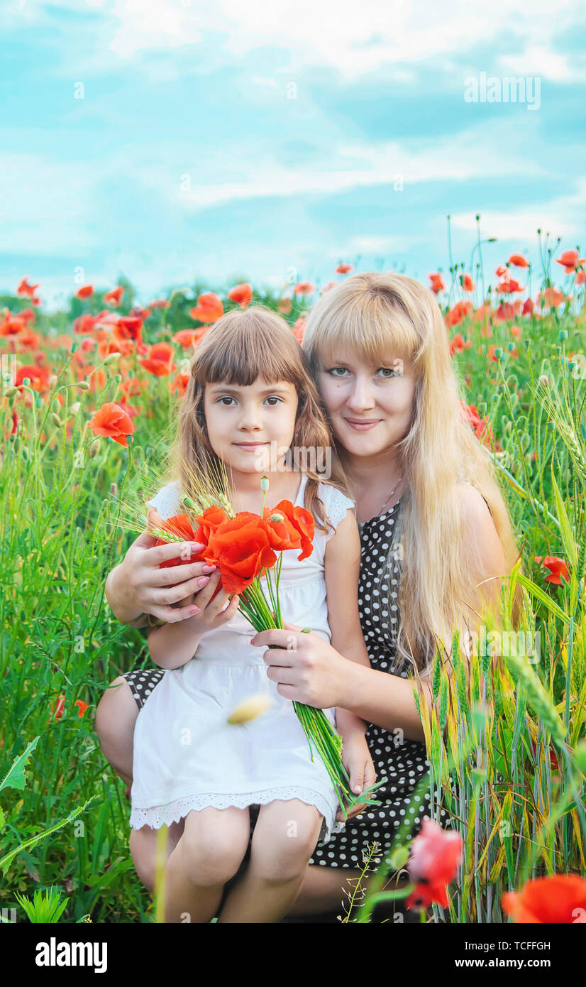 children girl in a field with poppies. selective focus Stock Photo - Alamy