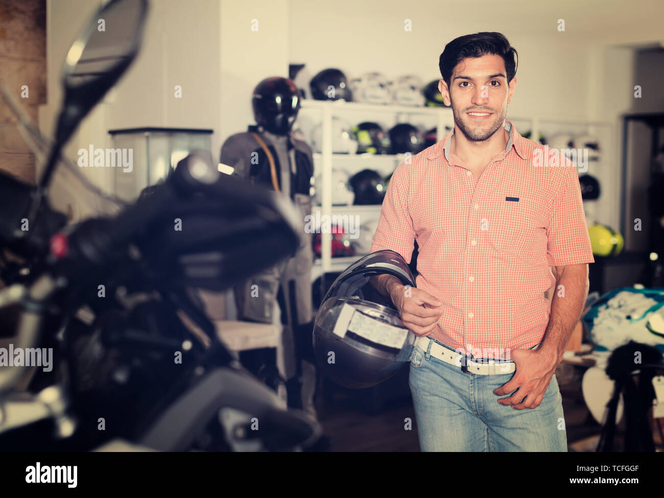 Portrait of glad cheerful positive male customer who is posing in new ...