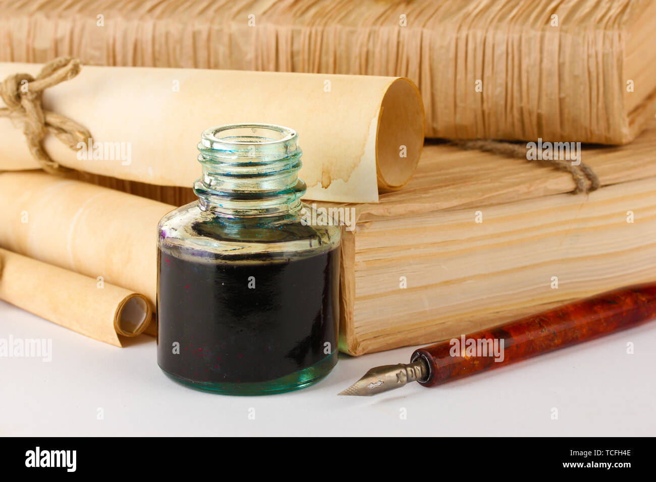 old books, ink pen and ink bottle isolated on white Stock Photo - Alamy