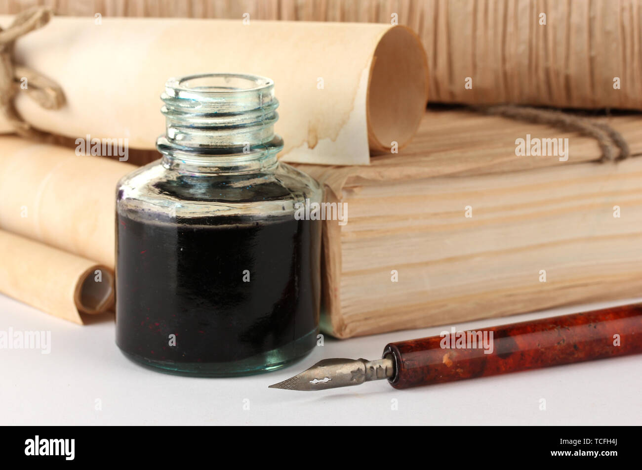 old books, ink pen and ink bottle isolated on white Stock Photo - Alamy