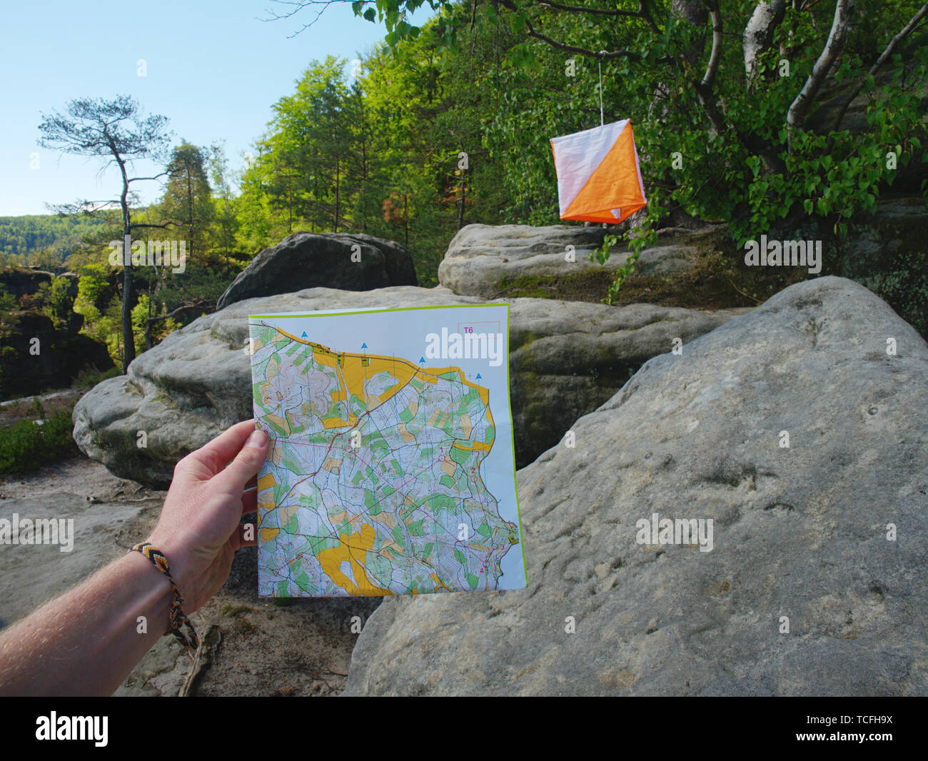 Athlete hand hold typical chart for orienteering sports. Person marks ...