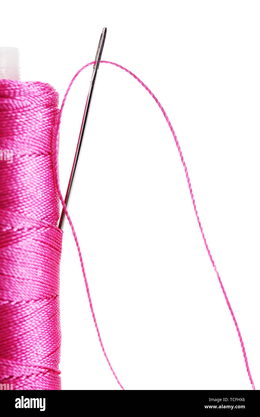 pink bobbin thread with needle isolated on white Stock Photo - Alamy